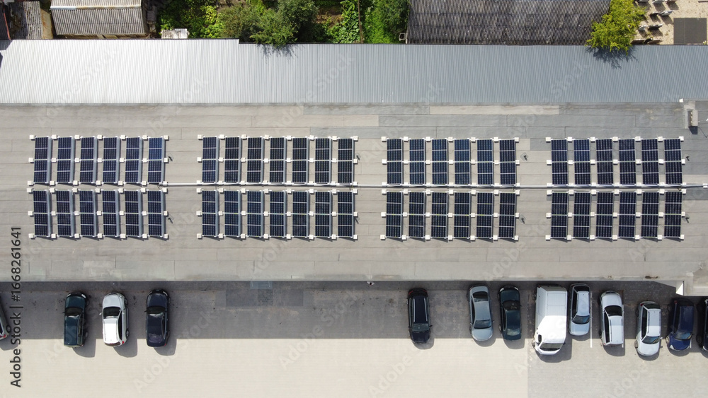 Aerial top view of multiple solar panels mounted on a flat roof of an ...