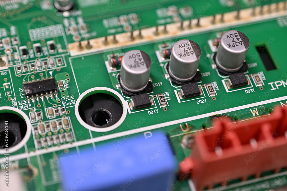 Close-up of rectifier diodes next to capacitors on a printed circuit ...