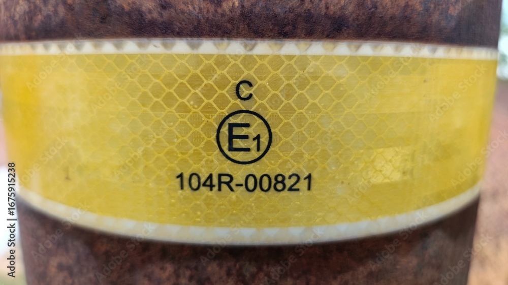 Reflective label with approval marks "E1", "C", and code "104R-00821 ...