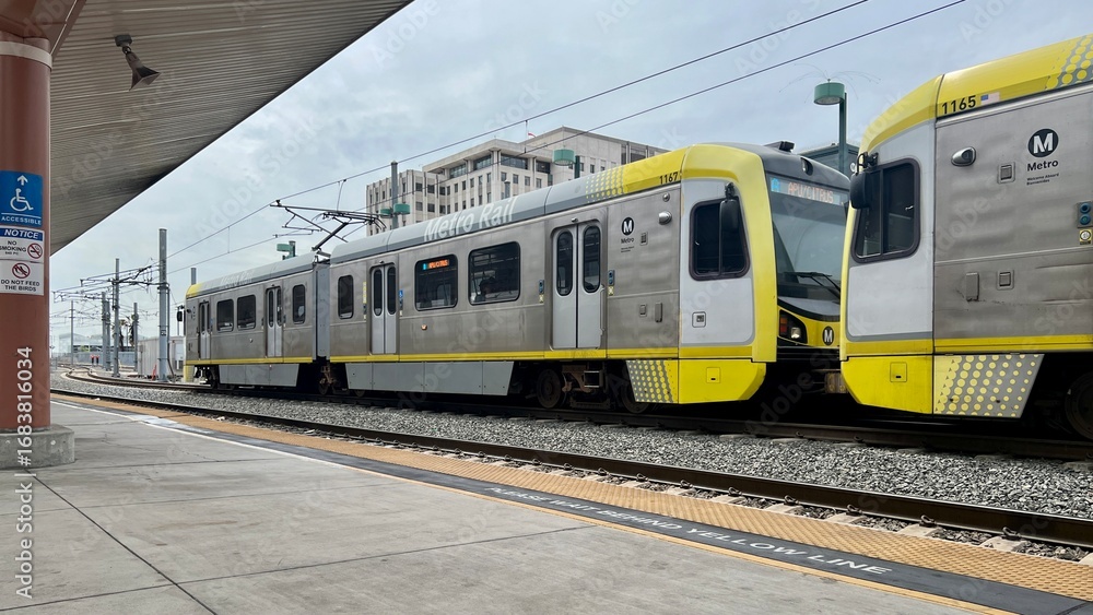LOS ANGELES, CA, AUG 28, 2025: LA Metro light rail trains at Union Station platform with yellow ...