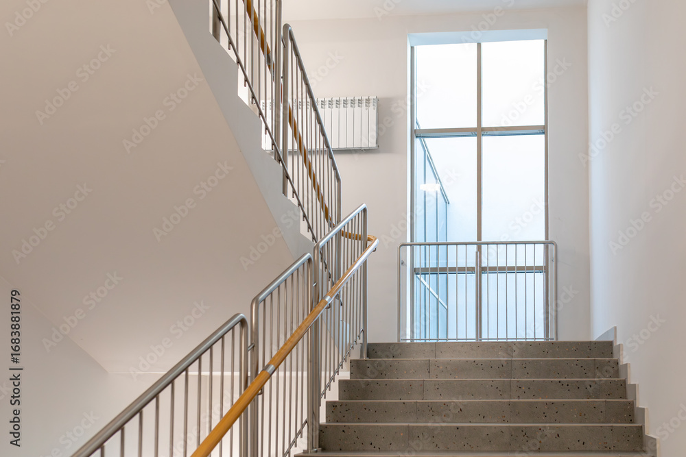 Staircase with metal railings and yellow handrail, modern interior ...
