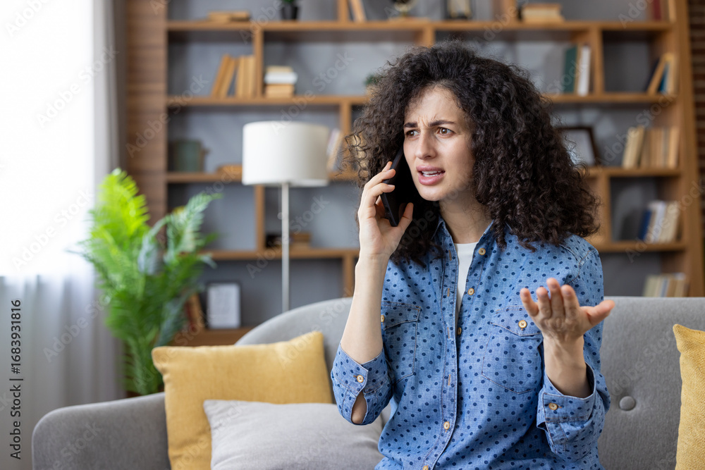 Frustrated woman arguing on phone at home Stock Photo | Adobe Stock