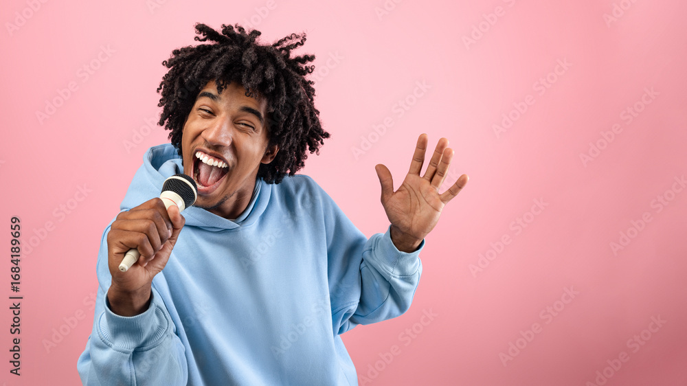 Rock star. Portrait of cool black teen guy singing song, using ...