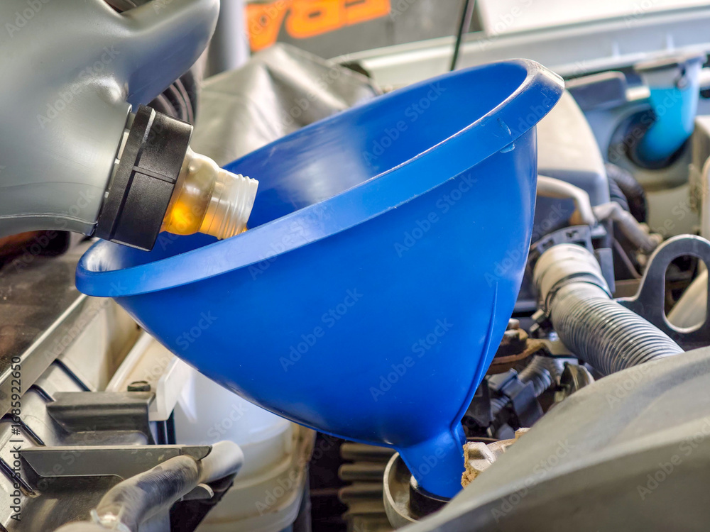 Refueling and pouring oil quality into the engine motor car ...
