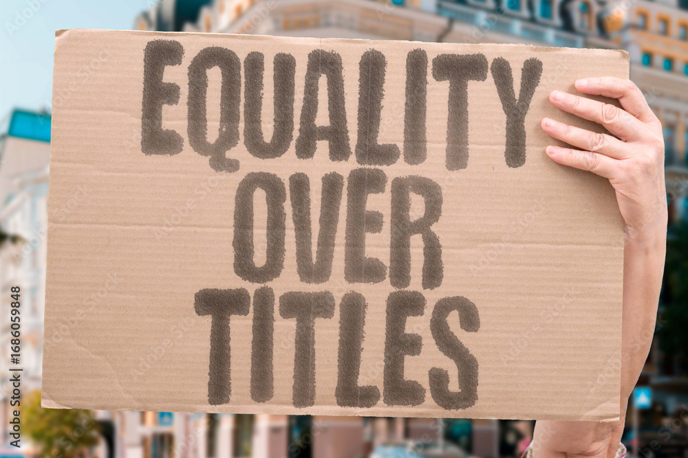 Fotografia do Stock "Equality Over Titles" appears on a cardboard ...