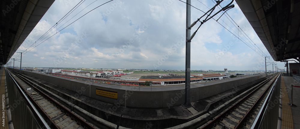 Elevated platform panorama showing railway tracks curving toward an ...