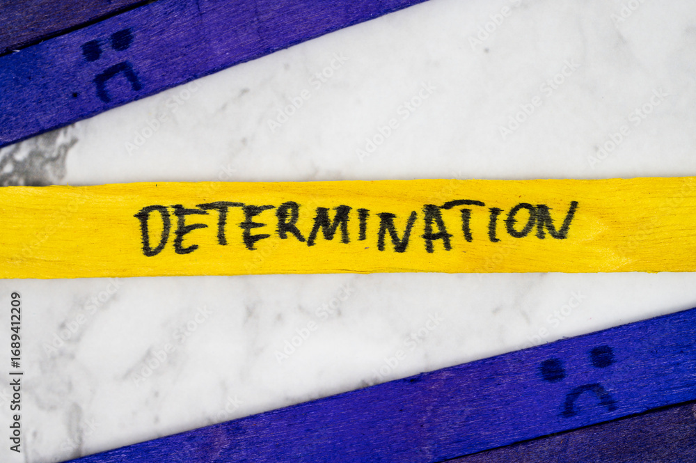 Yellow stick with handwritten word Determination placed between two ...