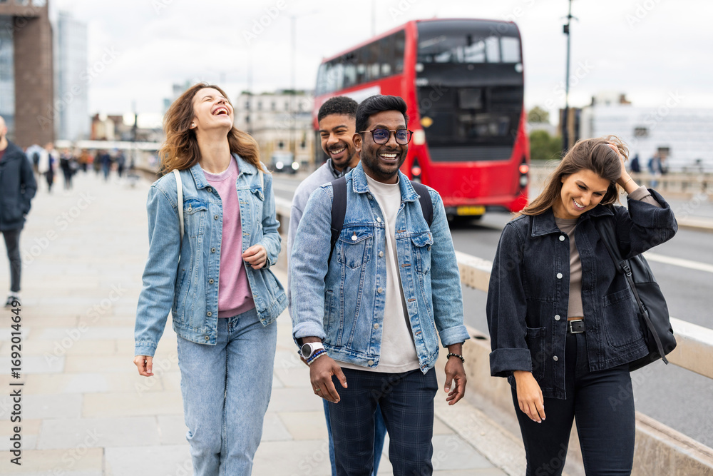 Happy group of friends walking and laughing in London with double ...
