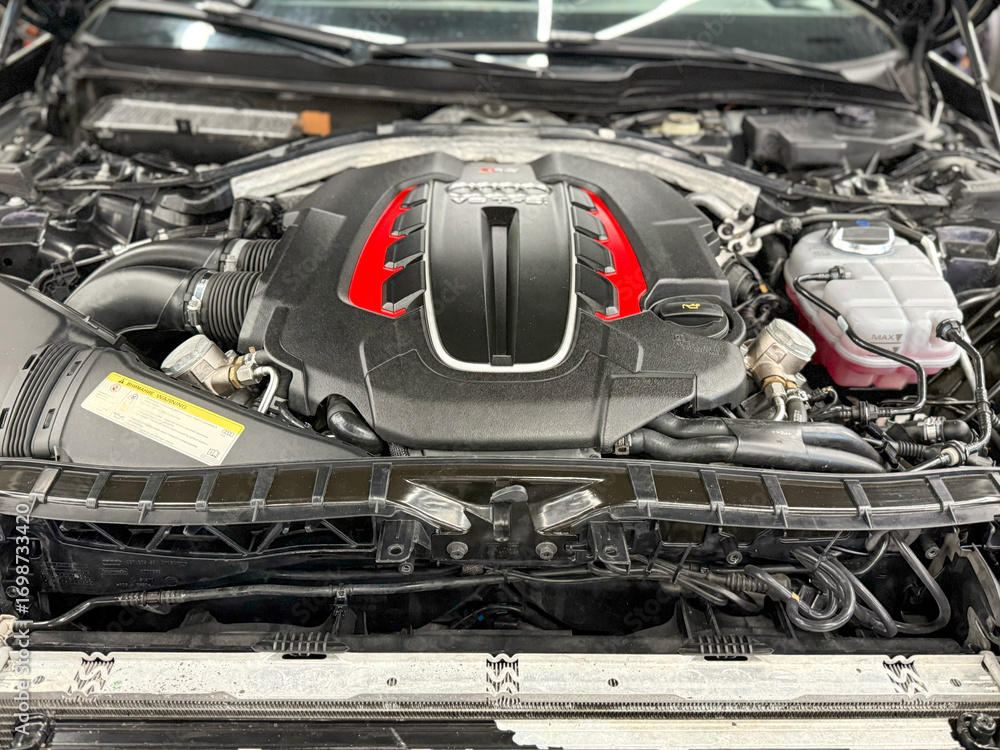 Engine of Audi V8 that powers RS models. Plastic engine cover with red ...