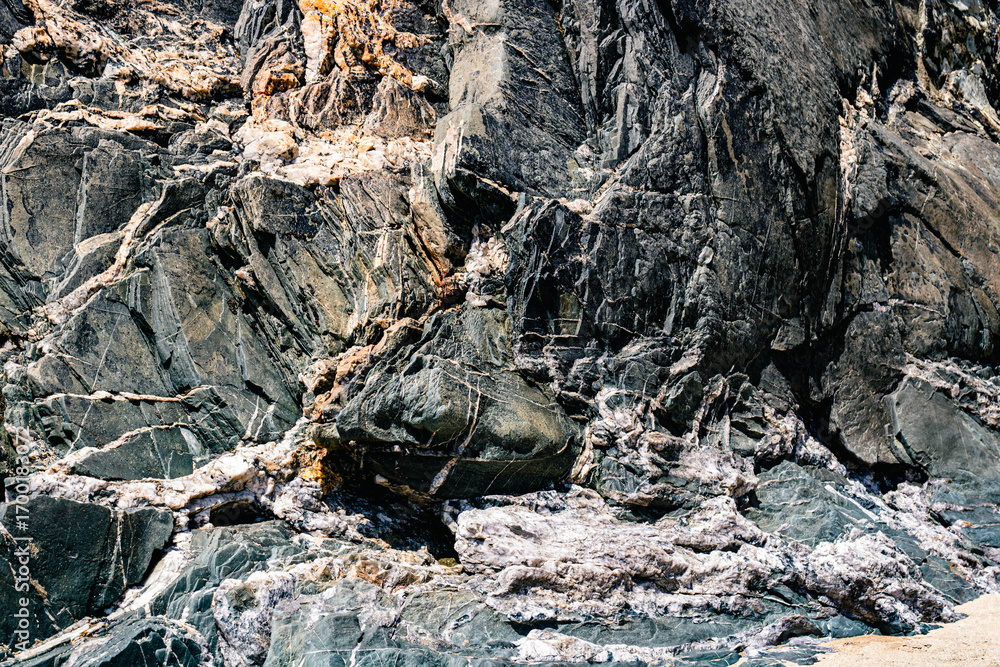 Cliff igneous rock texture with inclusions on the beach Stock Photo ...