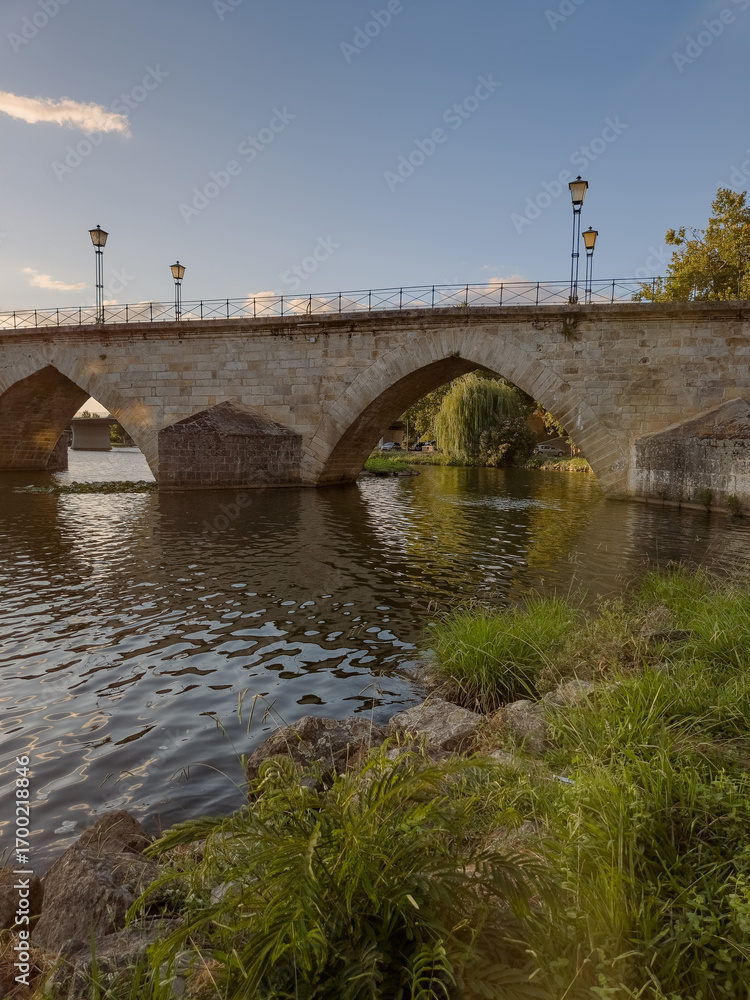 Stone bridge over the Tua River in Mirandela, Portugal, with granite ...