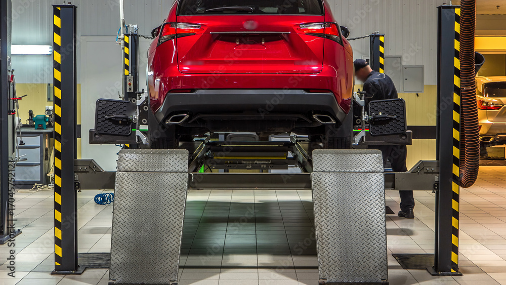 Car on stand with sensors on wheels for wheels alignment camber check ...