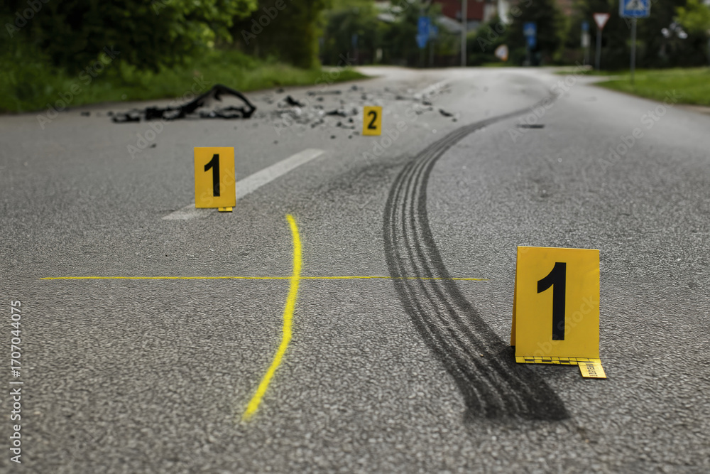 Forensic crash scene investigation with tire marks and evidence markers ...