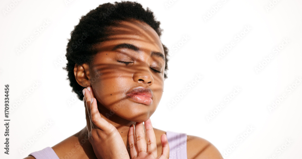 Skincare, black woman and thinking with shadow in studio, spa treatment ...