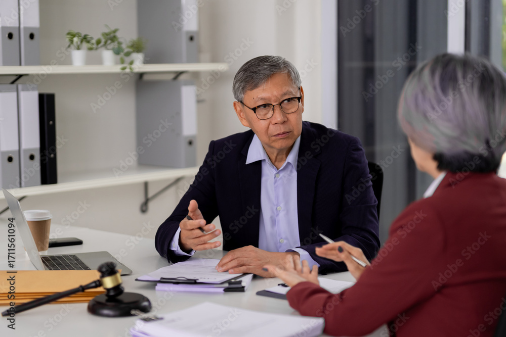 Asian senior lawyer consults client discussing complex legal matters ...