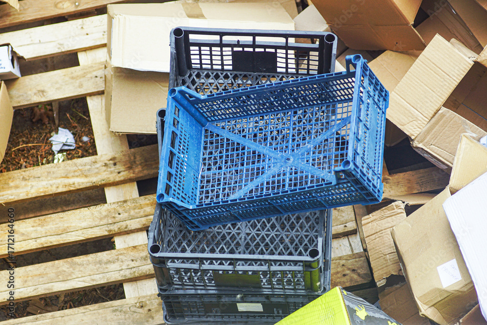 Empty plastic crates, cardboard boxes and wooden pallets. Symbol of ...