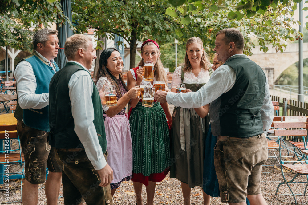 Friends in traditional Bavarian costume gather for celebration with ...