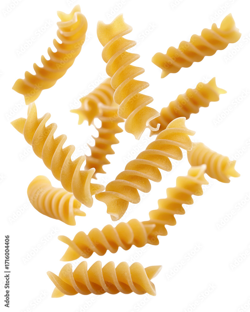 Rotini pasta falling against a black background showing texture and ...