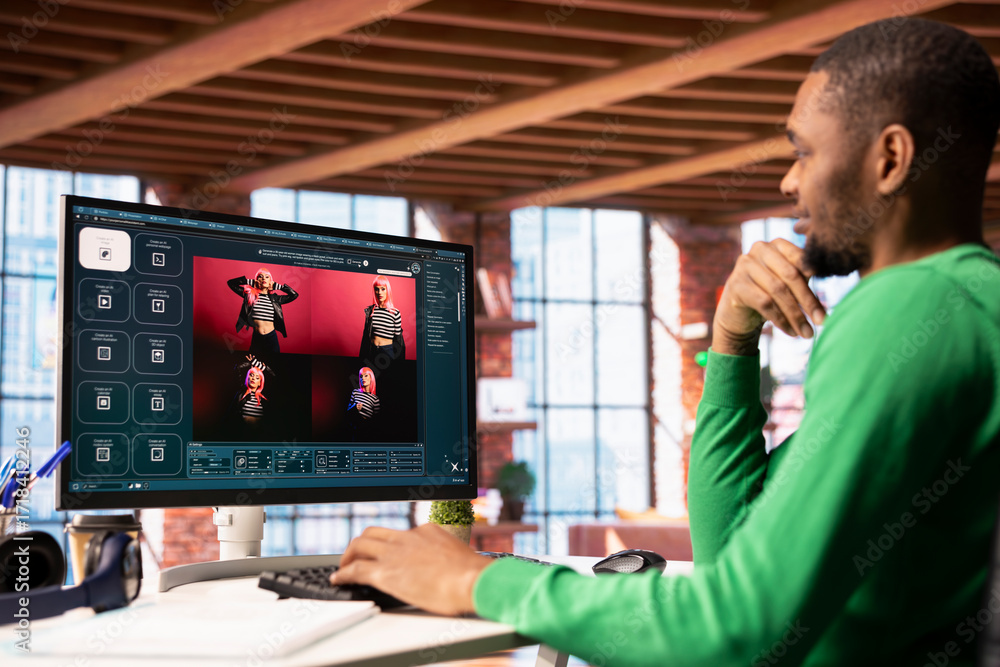 Smiling man in apartment workspace using AI software on computer ...