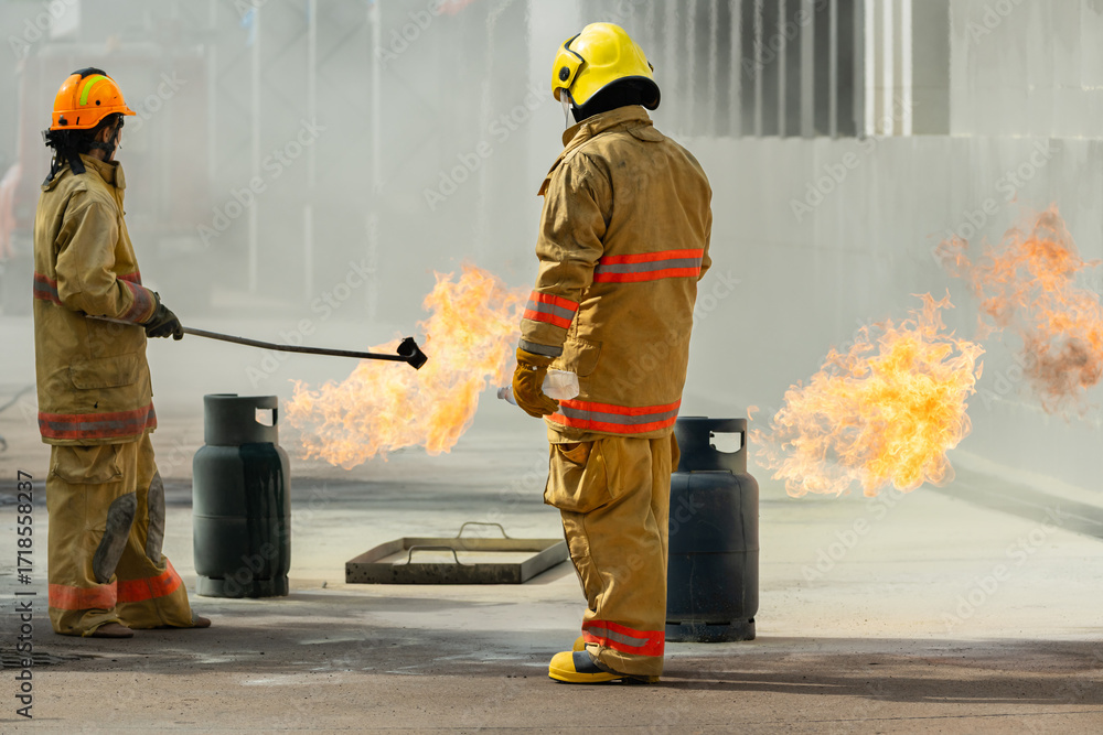 Firefighter showing how to use a fire extinguisher on a training for ...