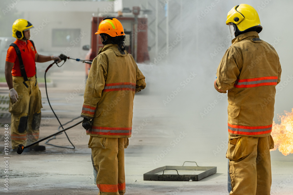 Firefighter showing how to use a fire extinguisher on a training for ...