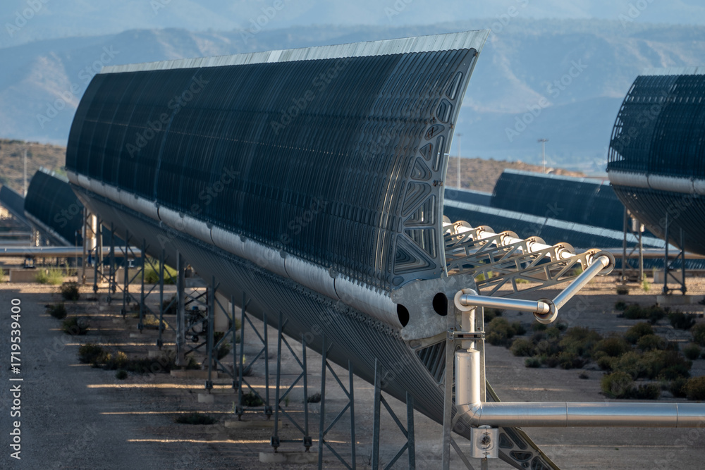 Solar thermal power station with rows of parabolic trough mirrors ...