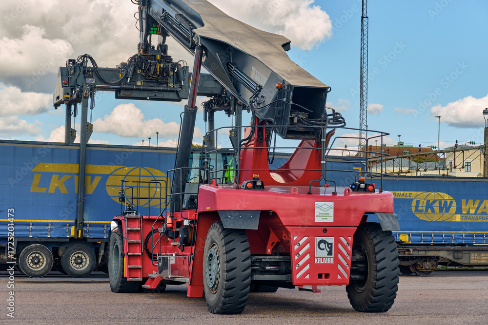 Kalmar reachstacker loading Walter LKW trailer onto rail wagon at ...