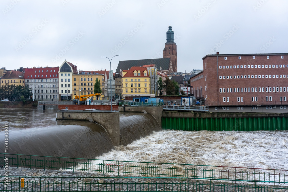 Stockfotot Stone weir dam with flowing water and colorful historic ...