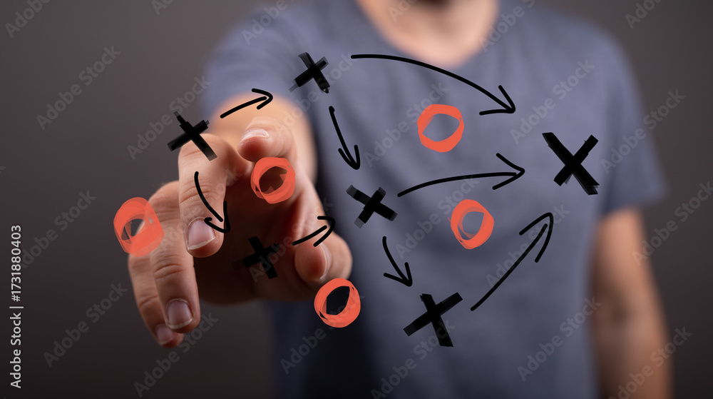 Strategic planning concept. Man points to a digital plan with Xs and Os ...