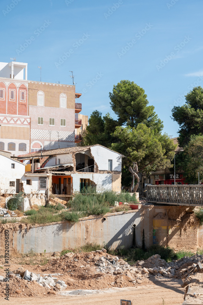 Damaged homes along river after flash flood in Valencia, one year after ...