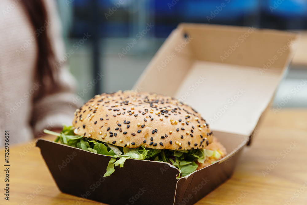 One burger in a box on a table on the terrace of a cafe. Stock Photo ...
