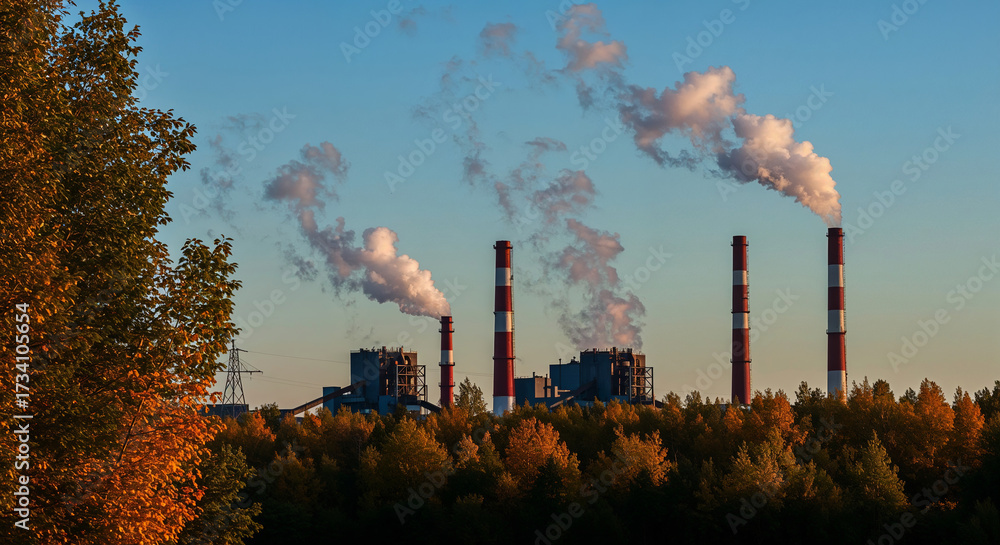 Industrial power plant with red and white striped smokestacks emitting ...