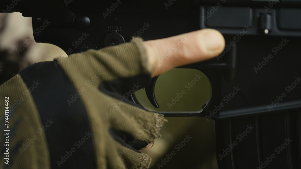 Soldier with AR15 carbine on a mission. Close-up finger pulling the ...