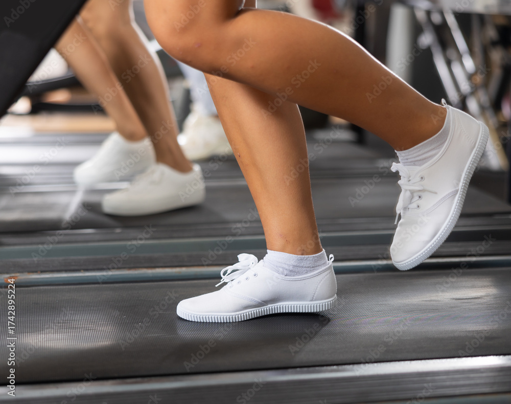 Feet of woman in sneakers training on treadmill in gym close-up Stock ...