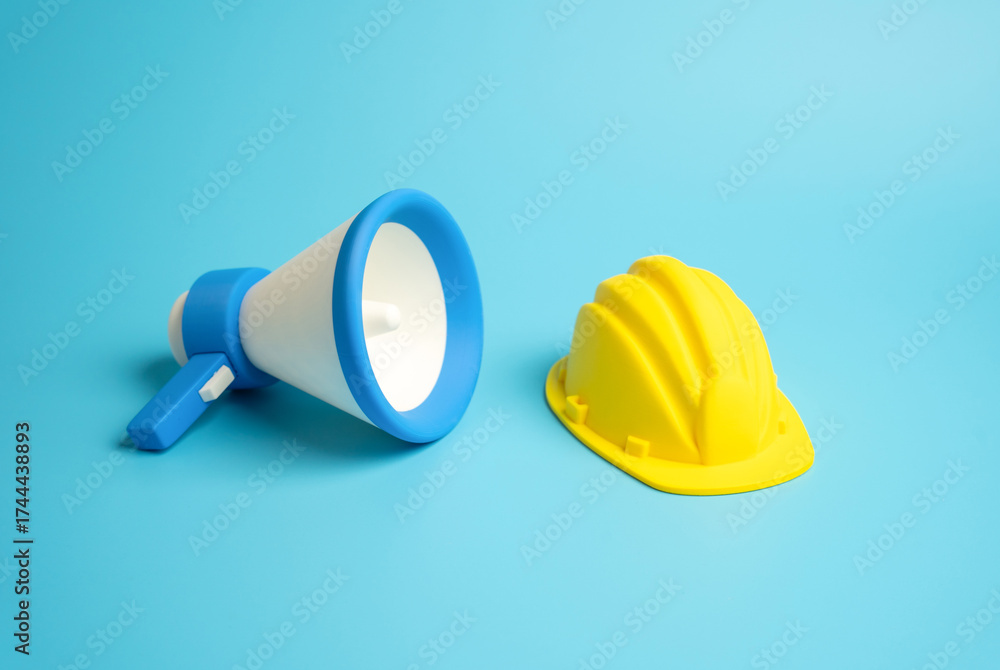 Stock-Foto „Megaphone and a hard construction helmet. Safety ...