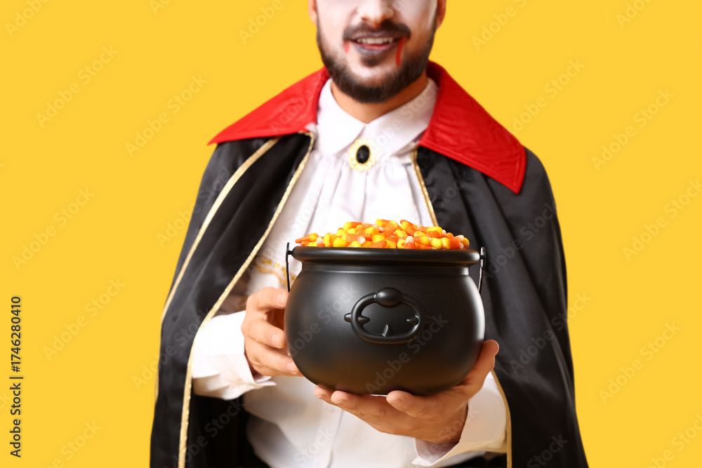 Stock-Foto „Young man dressed as vampire for Halloween with cauldron of ...
