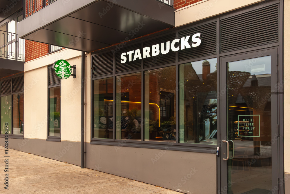 Starbucks logo on a facade of the modern residential building next to ...