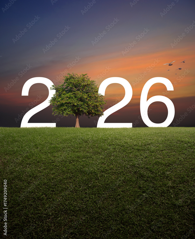 2026 white text with tree on green grass field over sunset sky with ...