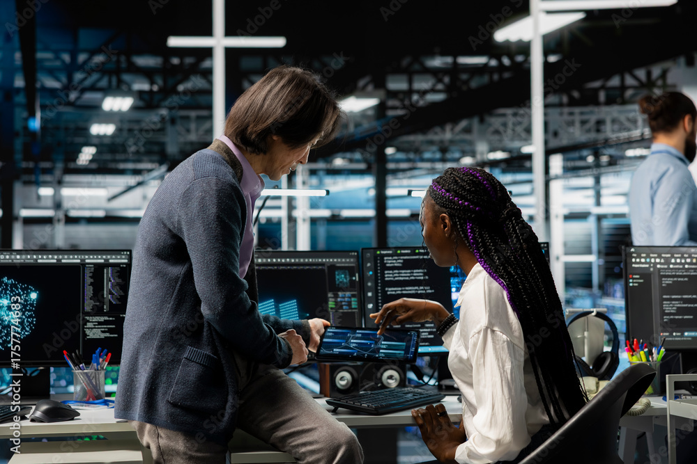 Photo Stock Team leader helping intern in data center to use AI LLM ...
