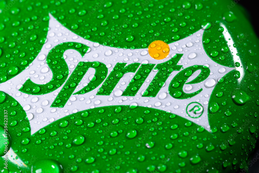 Sprite logo on a bottle cap with water drops in macro. A lid of cool ...