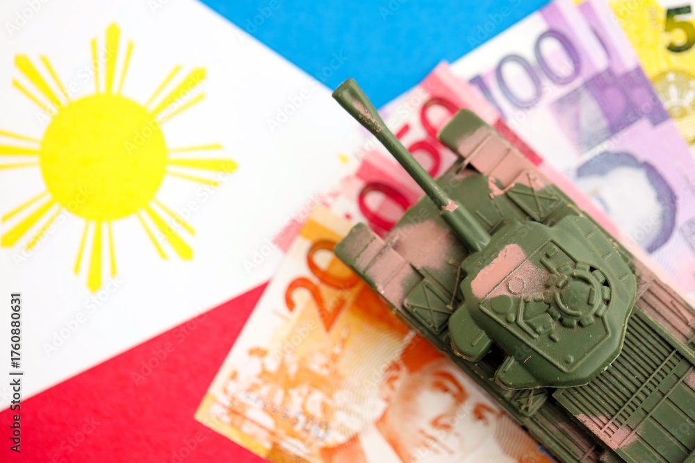 Philippines peso currency money bills and toy tank on flag close up ...