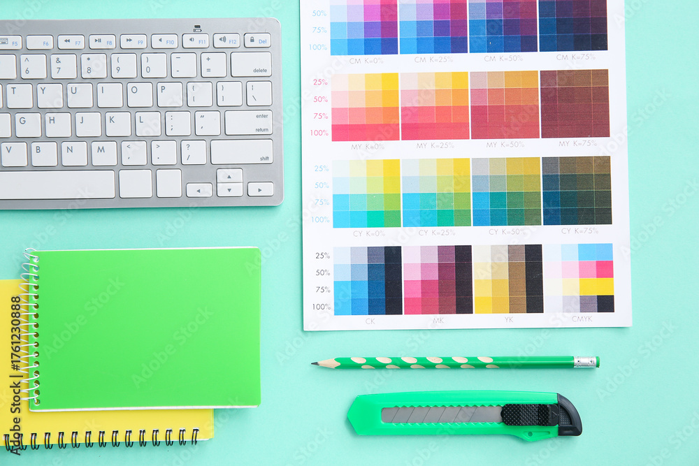 Workplace of graphic designer with keyboard, color charts and ...