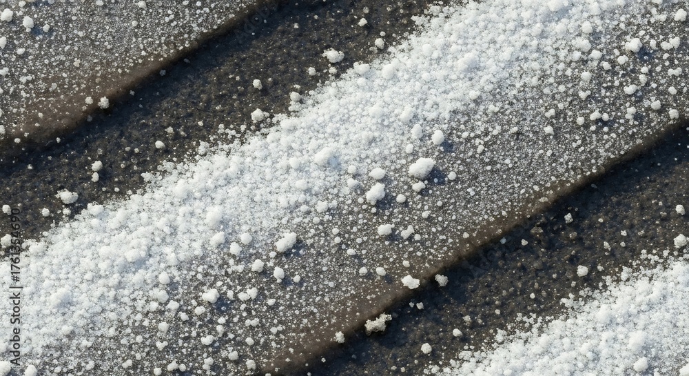 White granular substance lines a dark surface with raised edges Stock ...