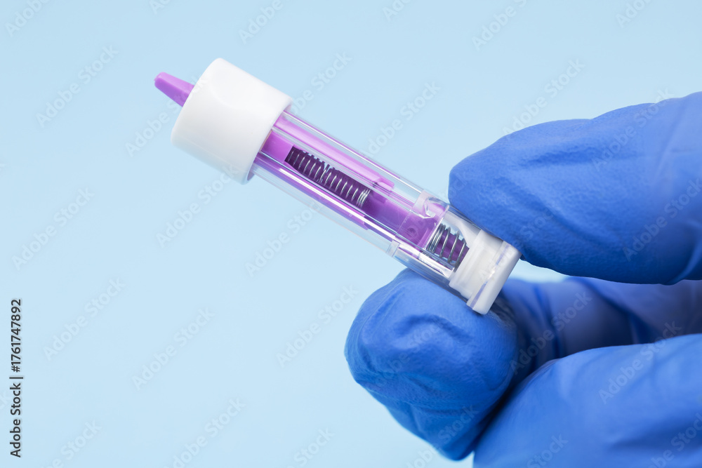 Disposable safety lancets in doctor hand, used to collect a blood ...