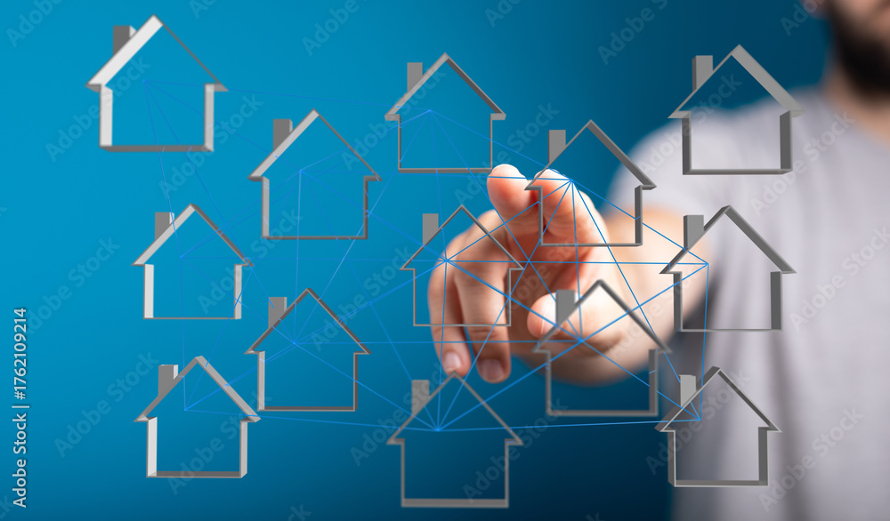 Conceptual image of a hand touching a network of connected house icons ...