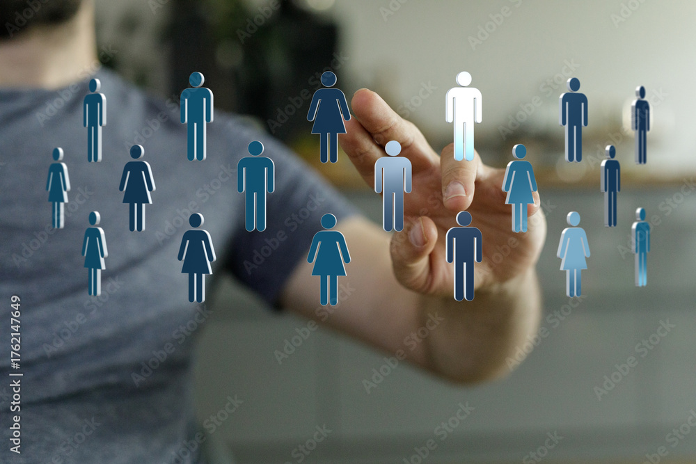Concept image of a man's hand selecting or influencing a group of ...