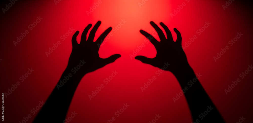 Silhouettes of two hands reaching or scratching on sinister red ...