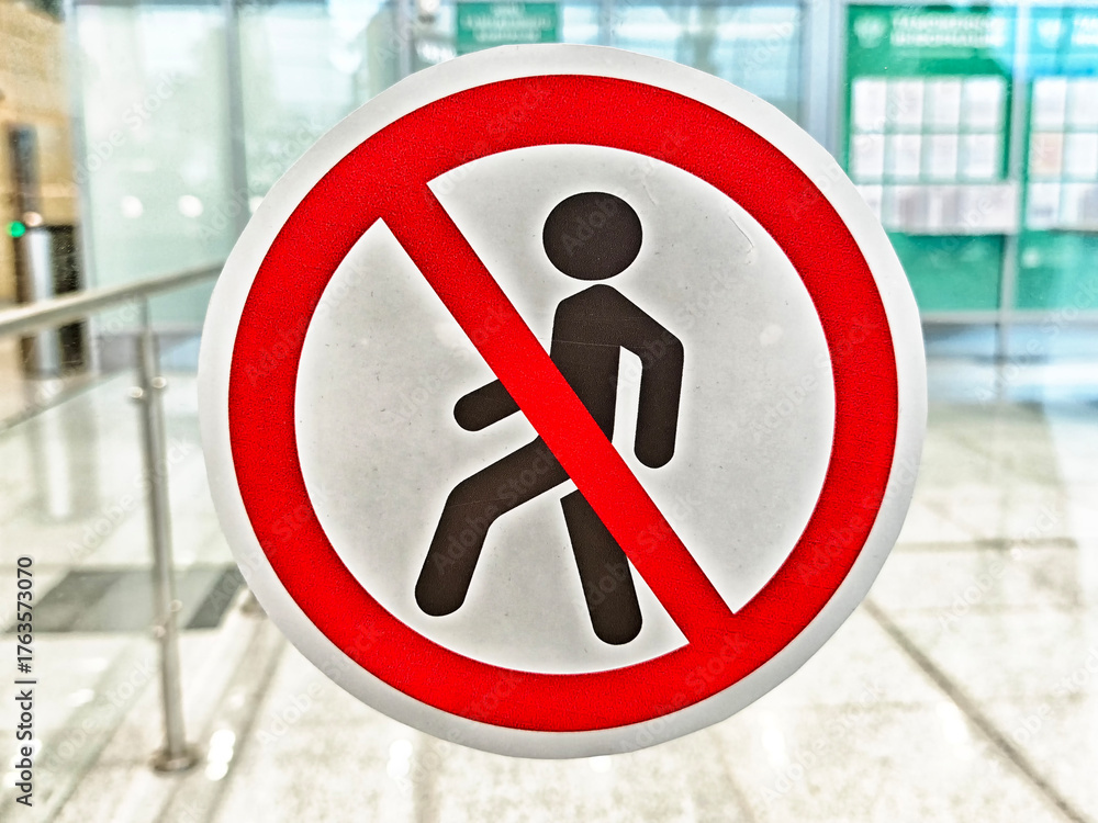 Sign indicating no one should walk in prohibited area within a public ...