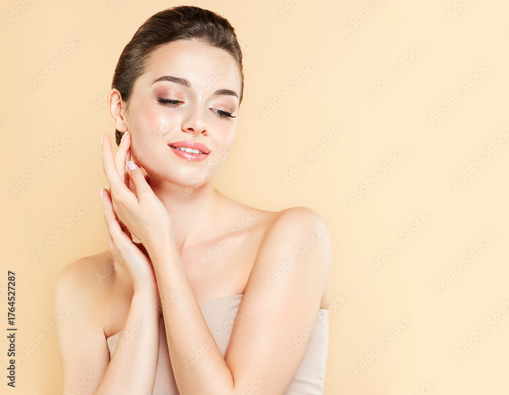 Beautiful young smilling woman with clean fresh skin .She gently ...