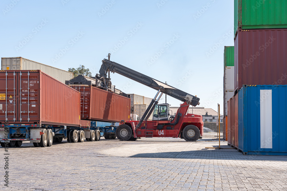 Reach stacker moving containers at a container yard in the port of ...